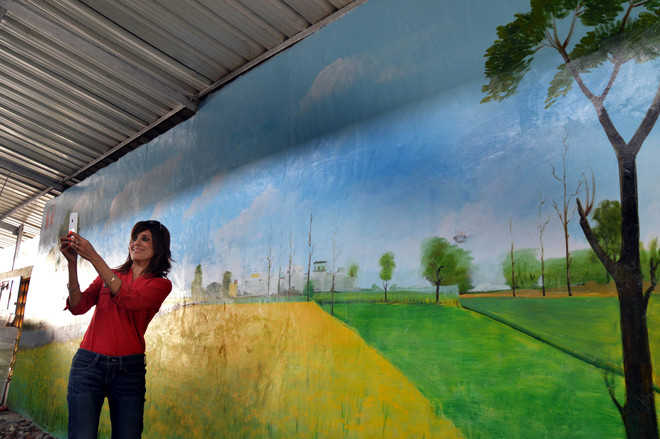 Rural Punjab murals an optic delight for visitors at rly station - The ...