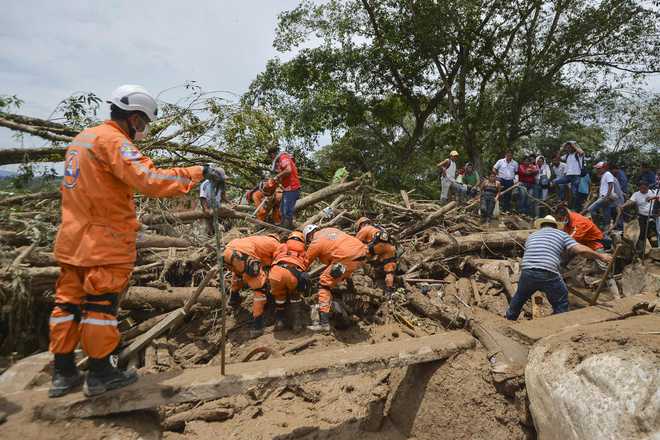 Rescuers, locals dig for Colombia flood victims - The Tribune