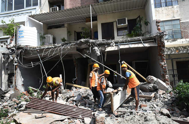 Demolition drive held amid protest - The Tribune